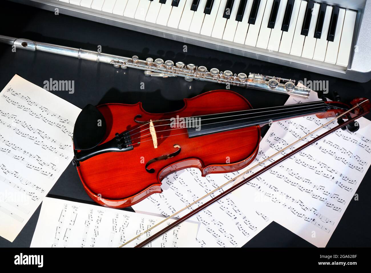 Musical instruments with music notes on dark background Stock Photo - Alamy