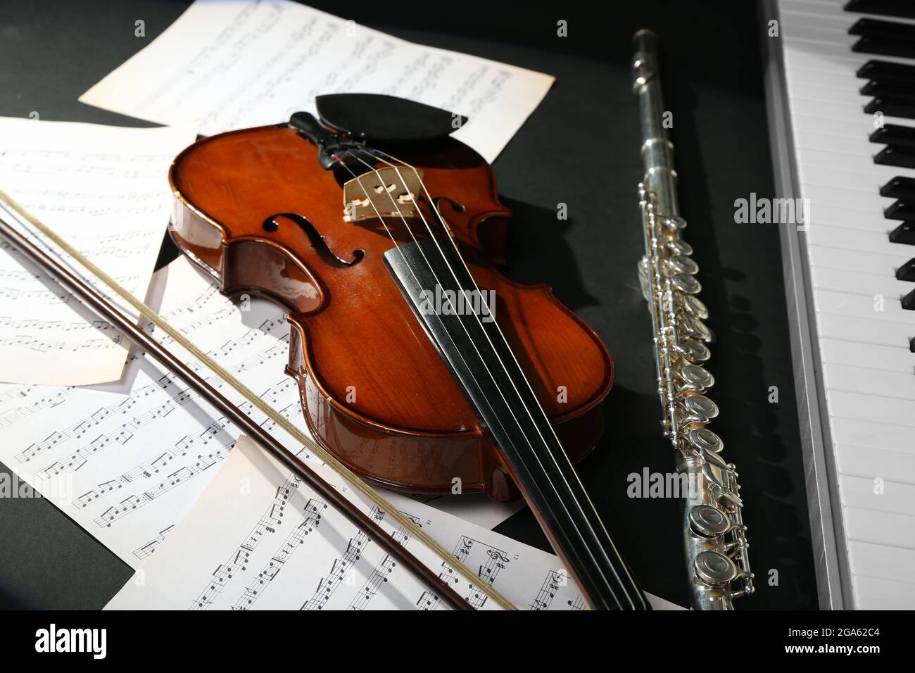 Musical instruments with music notes on dark background Stock Photo - Alamy