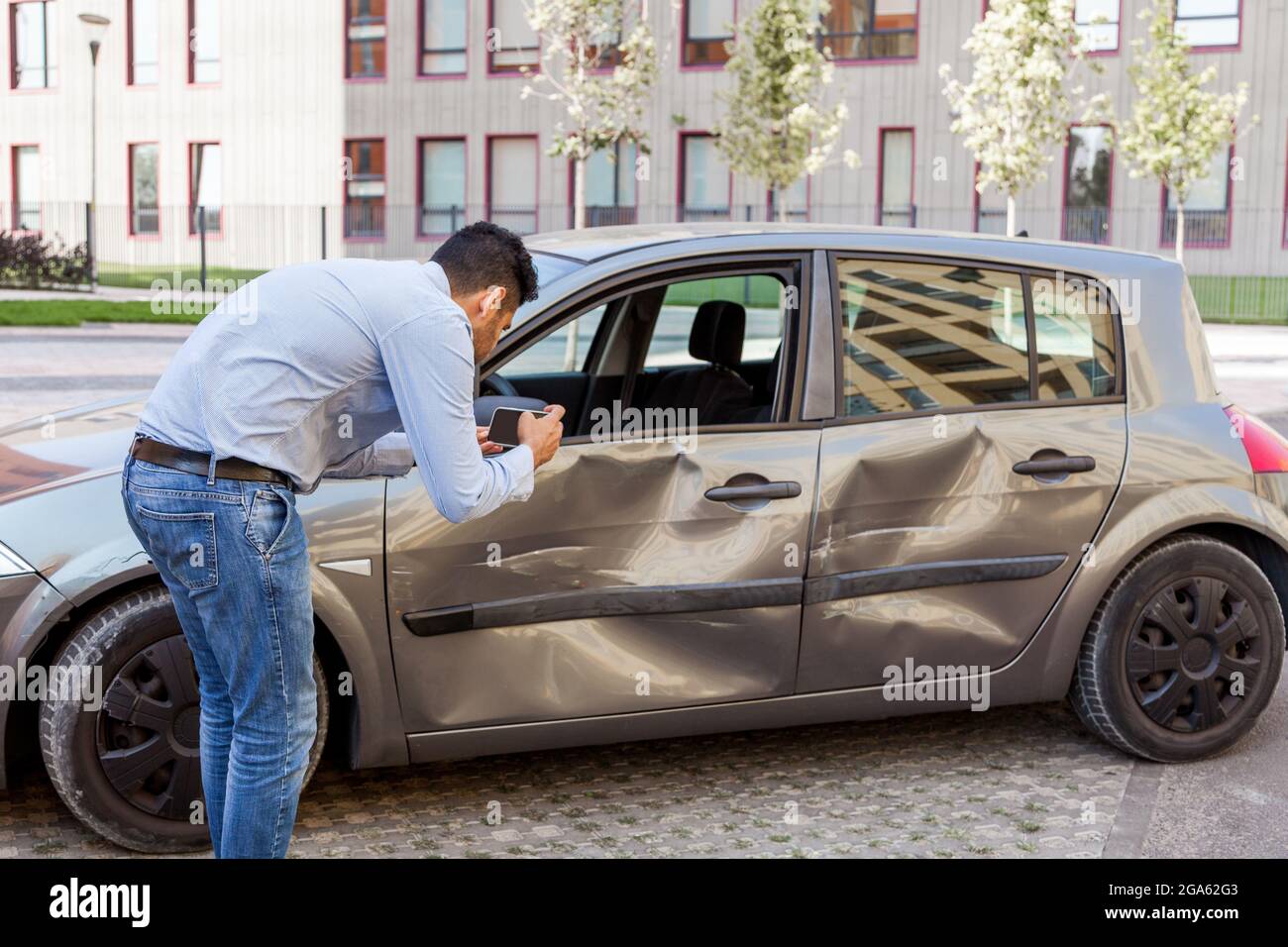 Side view portrait of man wearing jeans and shirt making photo of ...