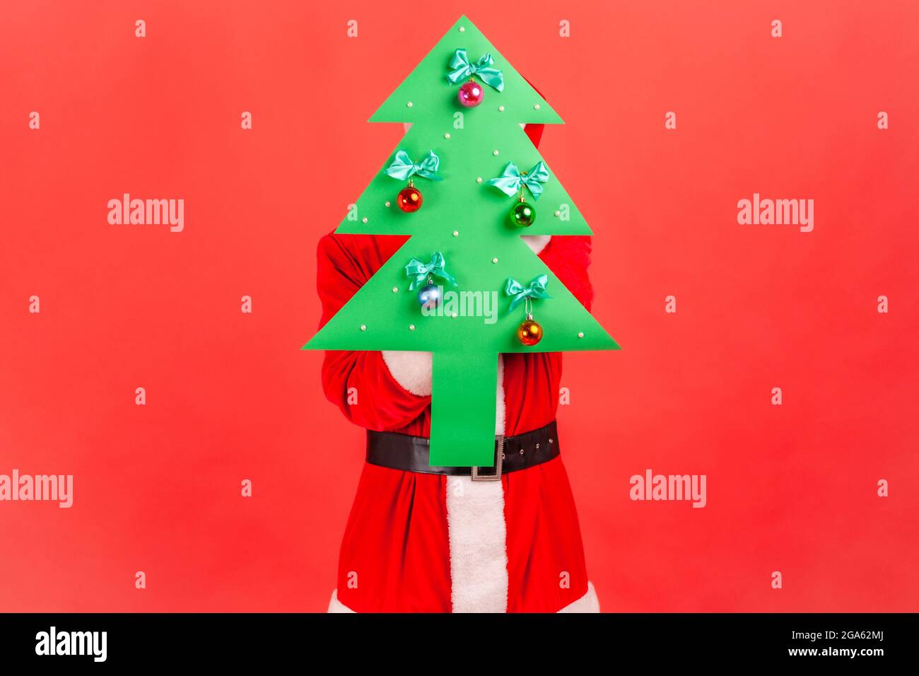Santa behind the tree hi-res stock photography and images - Alamy