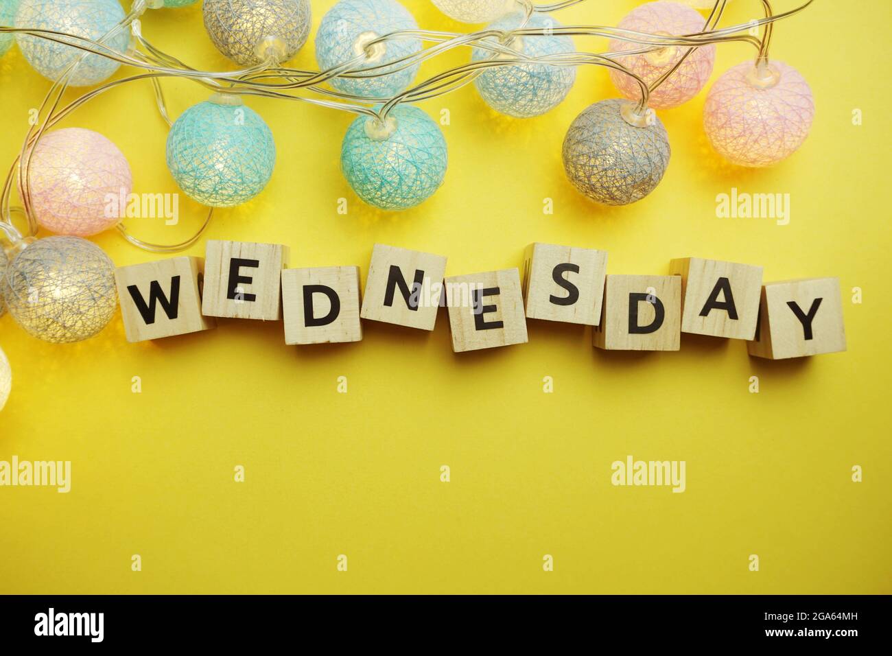 Wednesday alphabet letters with LED cotton balls decoration on yellow ...