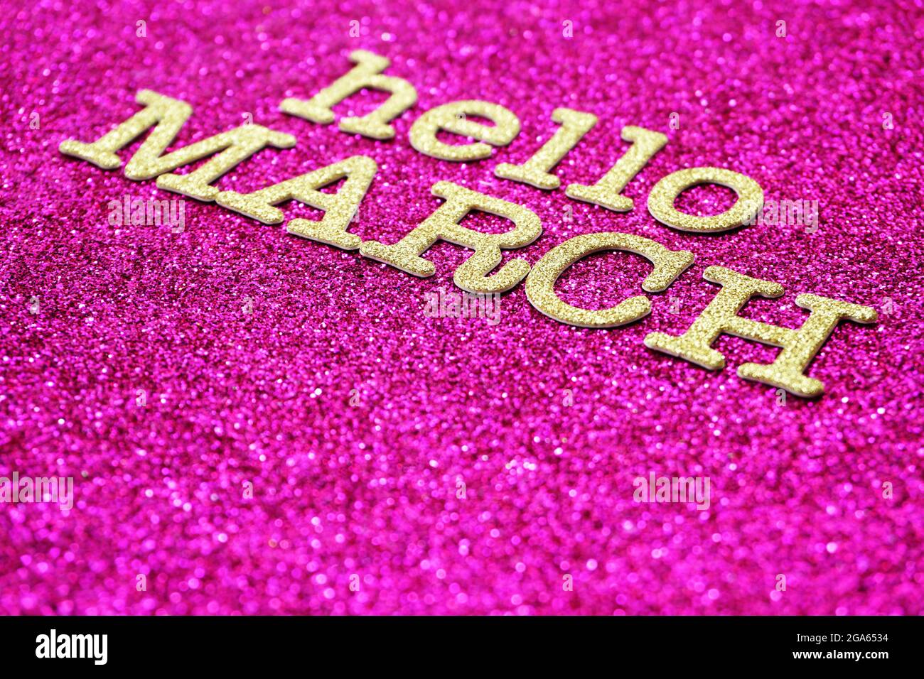 Hello March alphabet letters on pink glitter background Stock Photo - Alamy