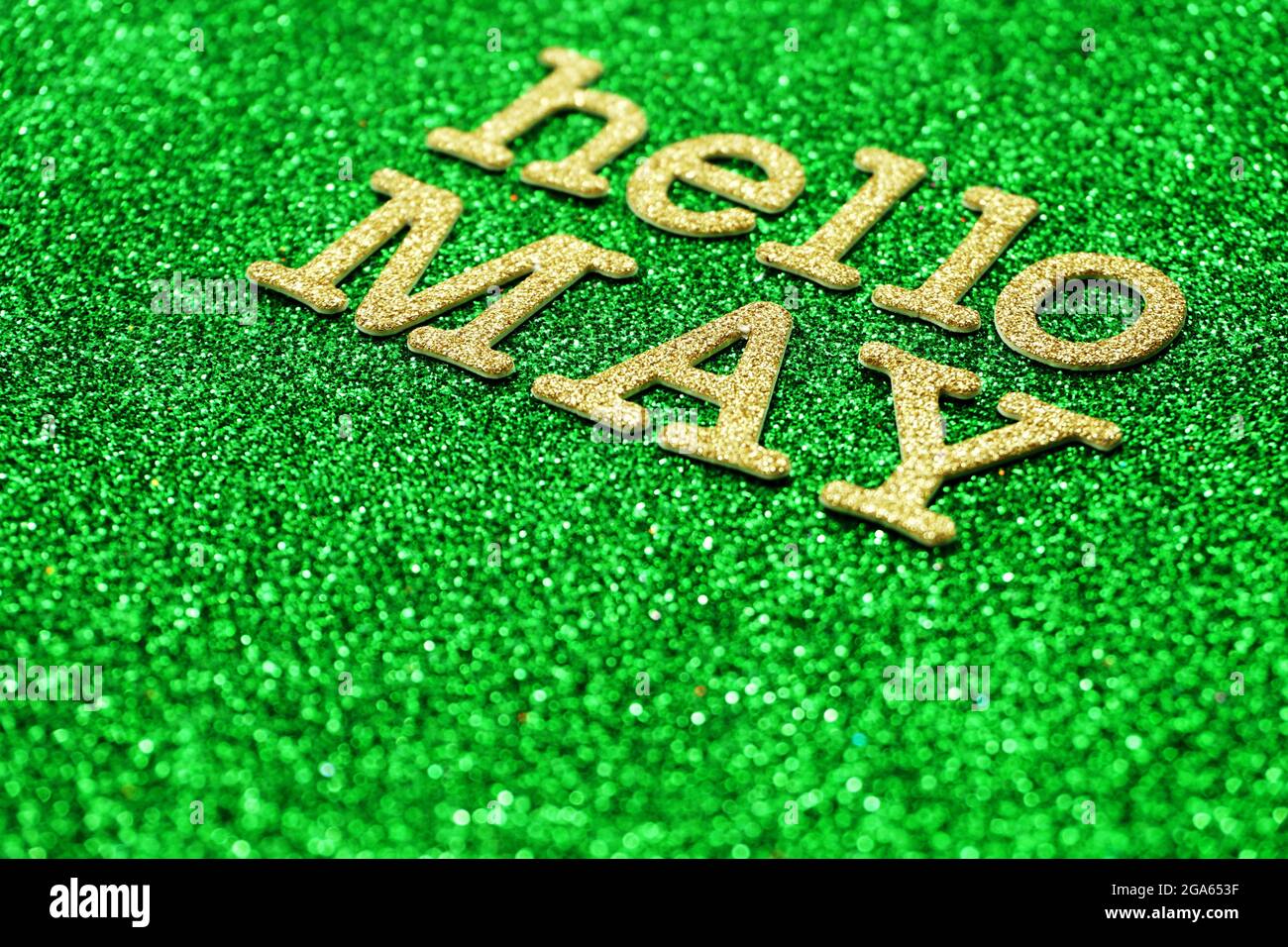 Hello May alphabet letters on green glitter background Stock Photo - Alamy
