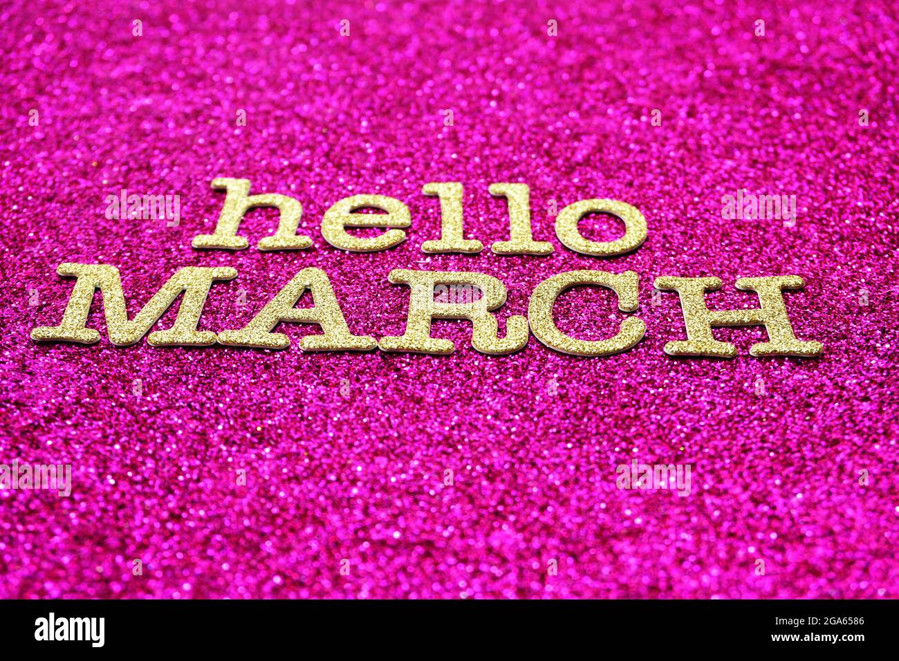 Hello March alphabet letters on pink glitter background Stock Photo - Alamy
