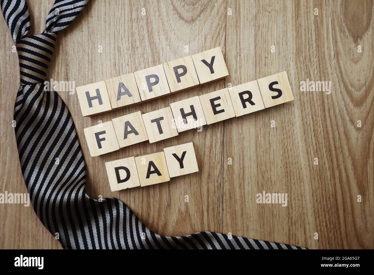 Happy Father's Day alphabet letters with necktie on wooden background ...