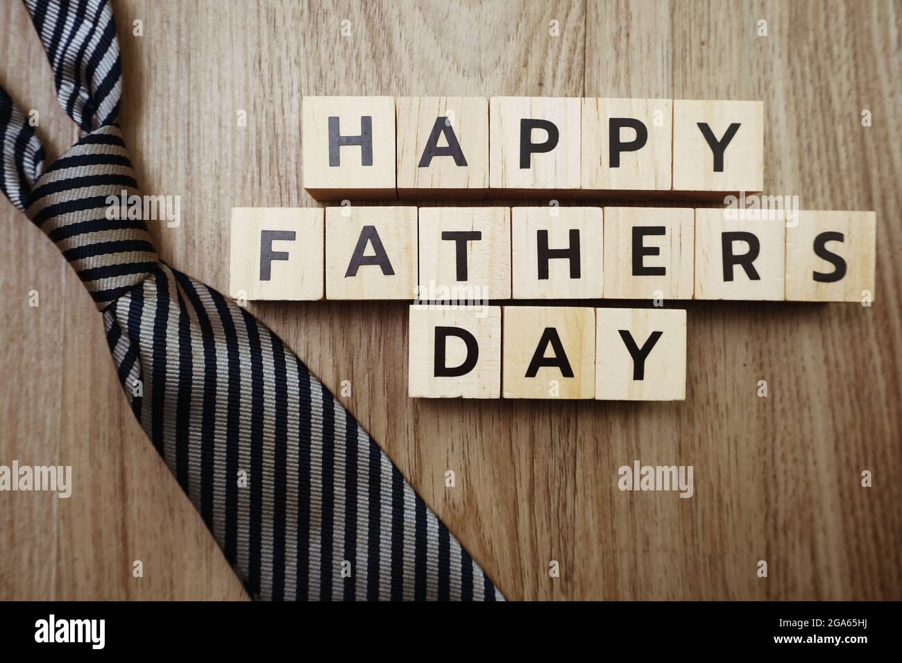 Happy Father's Day alphabet letters with necktie on wooden background ...