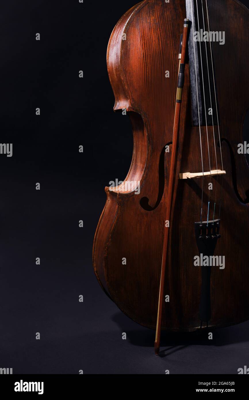 Vintage cello on dark background Stock Photo - Alamy
