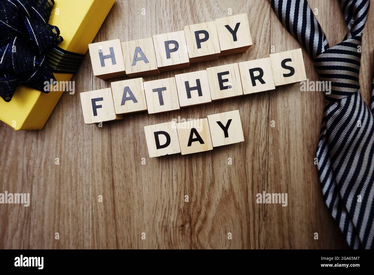 Happy Father's Day alphabet letters with necktie and gift box on wooden ...