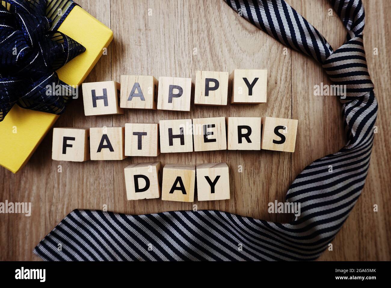 Happy Father's Day alphabet letters with necktie and gift box on wooden ...