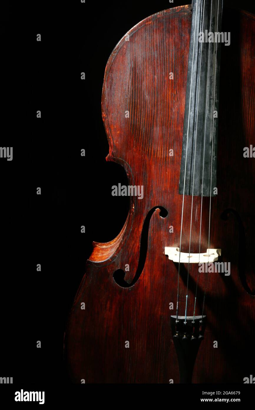 Vintage cello on dark background Stock Photo - Alamy
