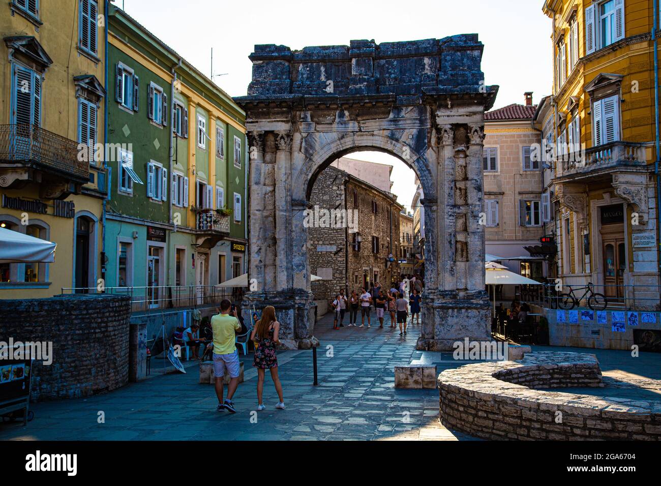 Stone gate of city wall, Mausole and church of Pula Stock Photo - Alamy