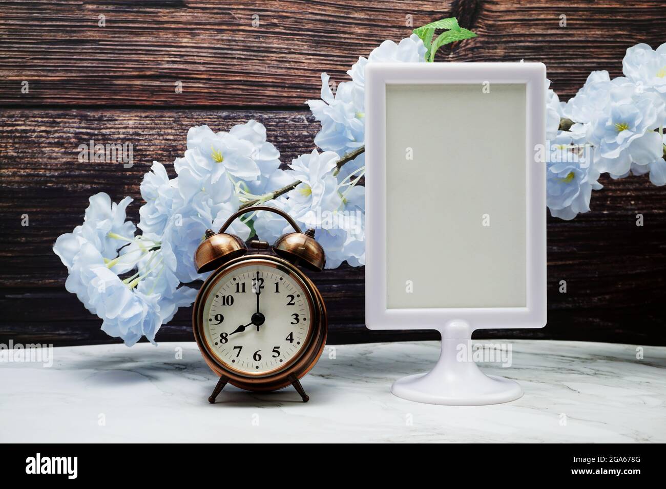Blank Display frame stand and alarm clock on wooden background Stock ...