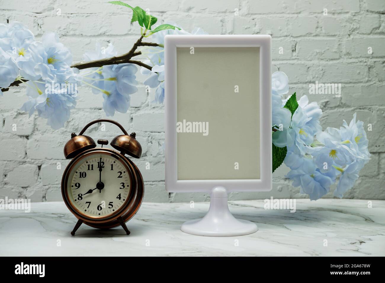 Blank Display frame stand and alarm clock on wooden background Stock ...