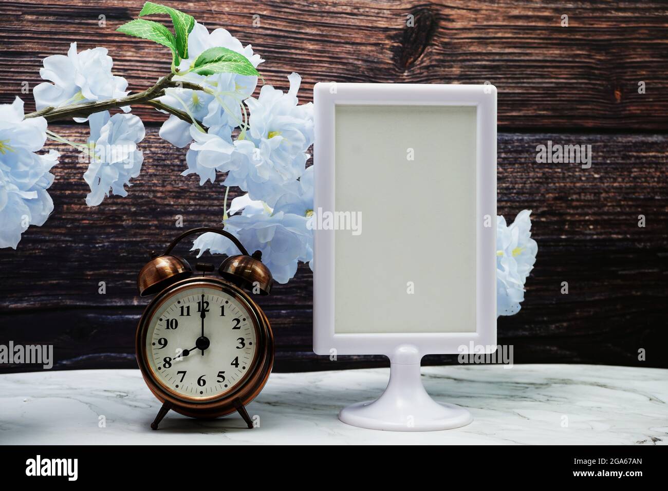 Blank Display frame stand and alarm clock on wooden background Stock ...