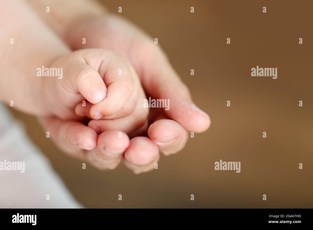 Adult and baby hands, closeup Stock Photo - Alamy