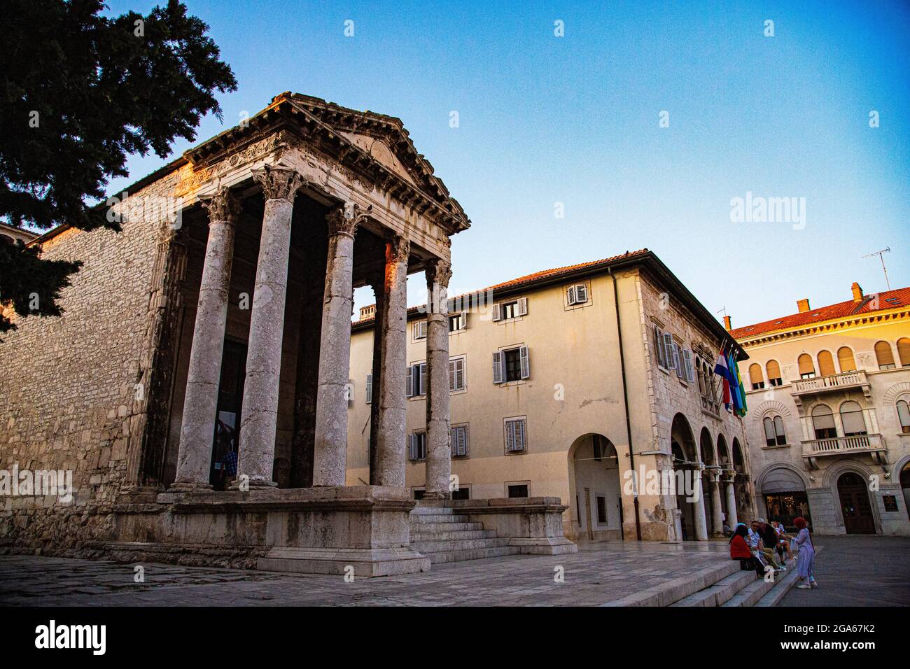 Stone gate of city wall, Mausole and church of Pula Stock Photo - Alamy
