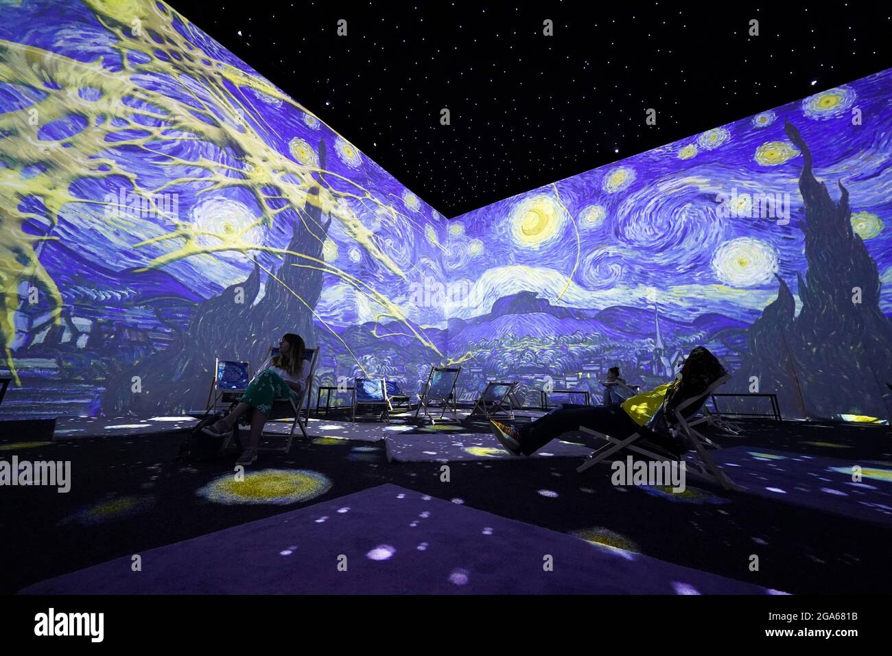 People watch a projection which is part of the Van Gogh: The Immersive ...