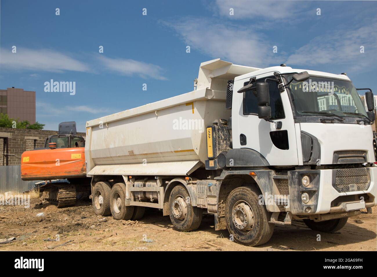 dump truck at work at a construction site. The process of loading soil ...