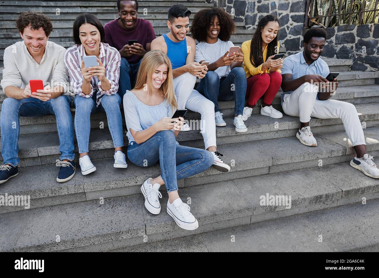 Happy diverse people using mobile phonesHappy diverse people using ...