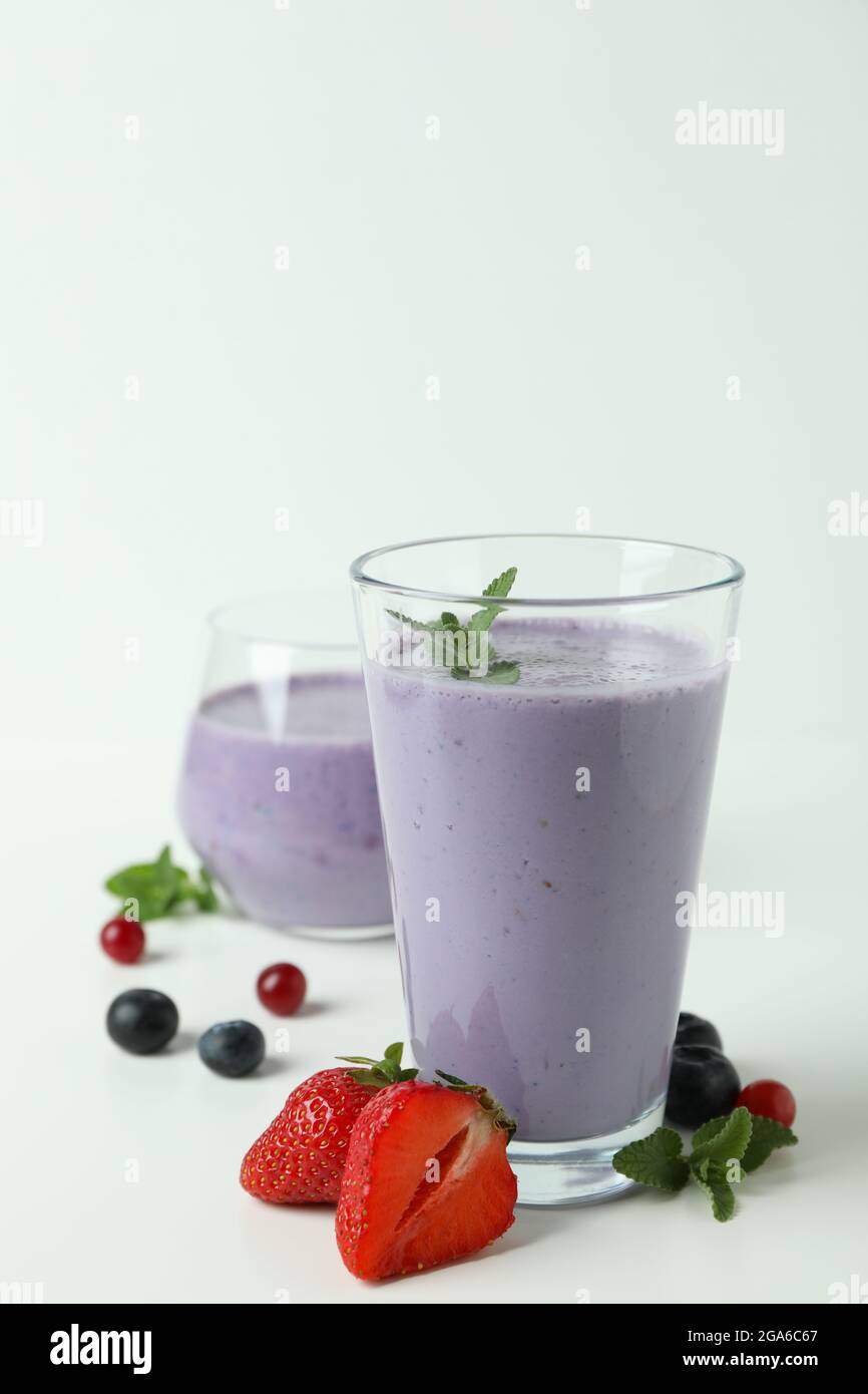 Glasses of smoothie and ingredients on white background Stock Photo - Alamy