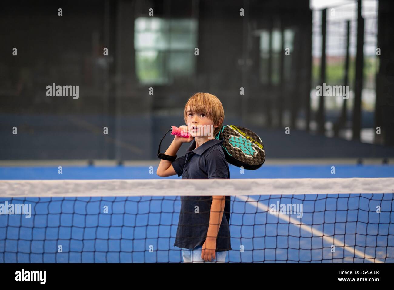 Monitor teaching padel class to child, his student - Trainer teaches ...