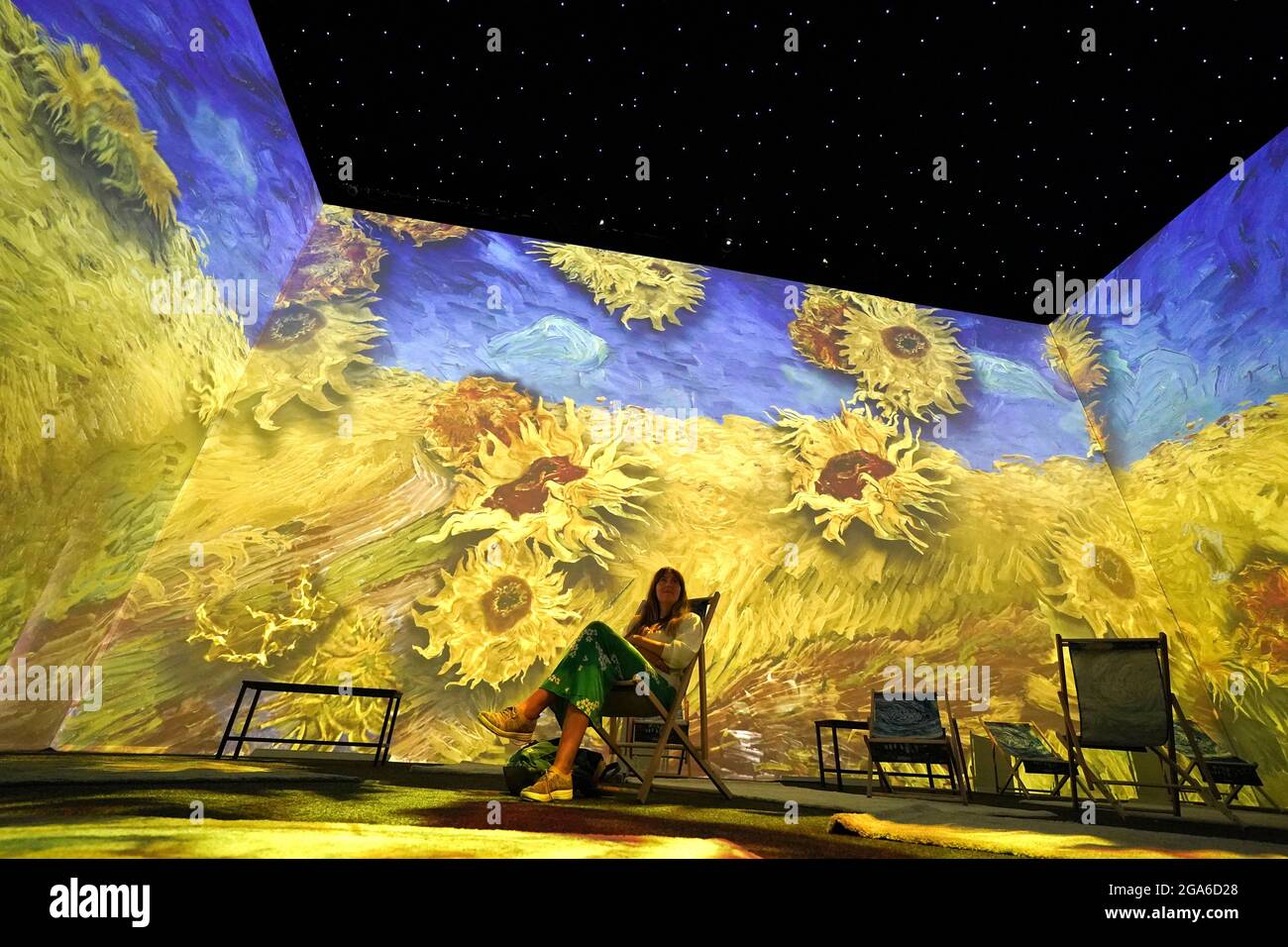 A woman watches a projection which is part of the Van Gogh: The ...
