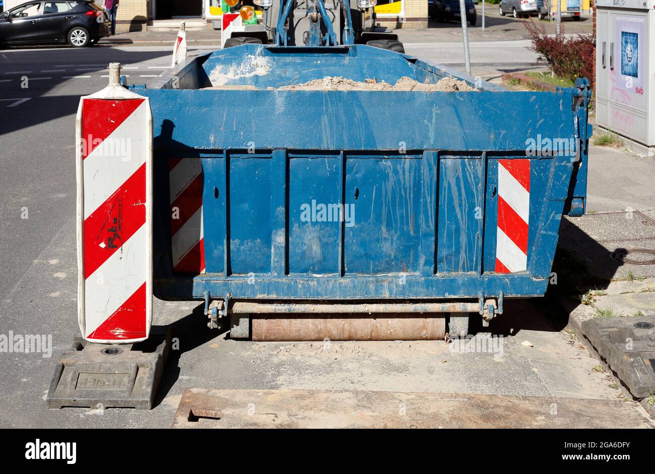 blue skip for building rubble standing on a construction site; Germany ...