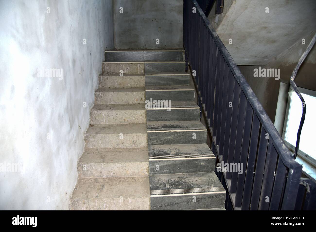 Floor tile installation process on concrete stair in multi-storey ...