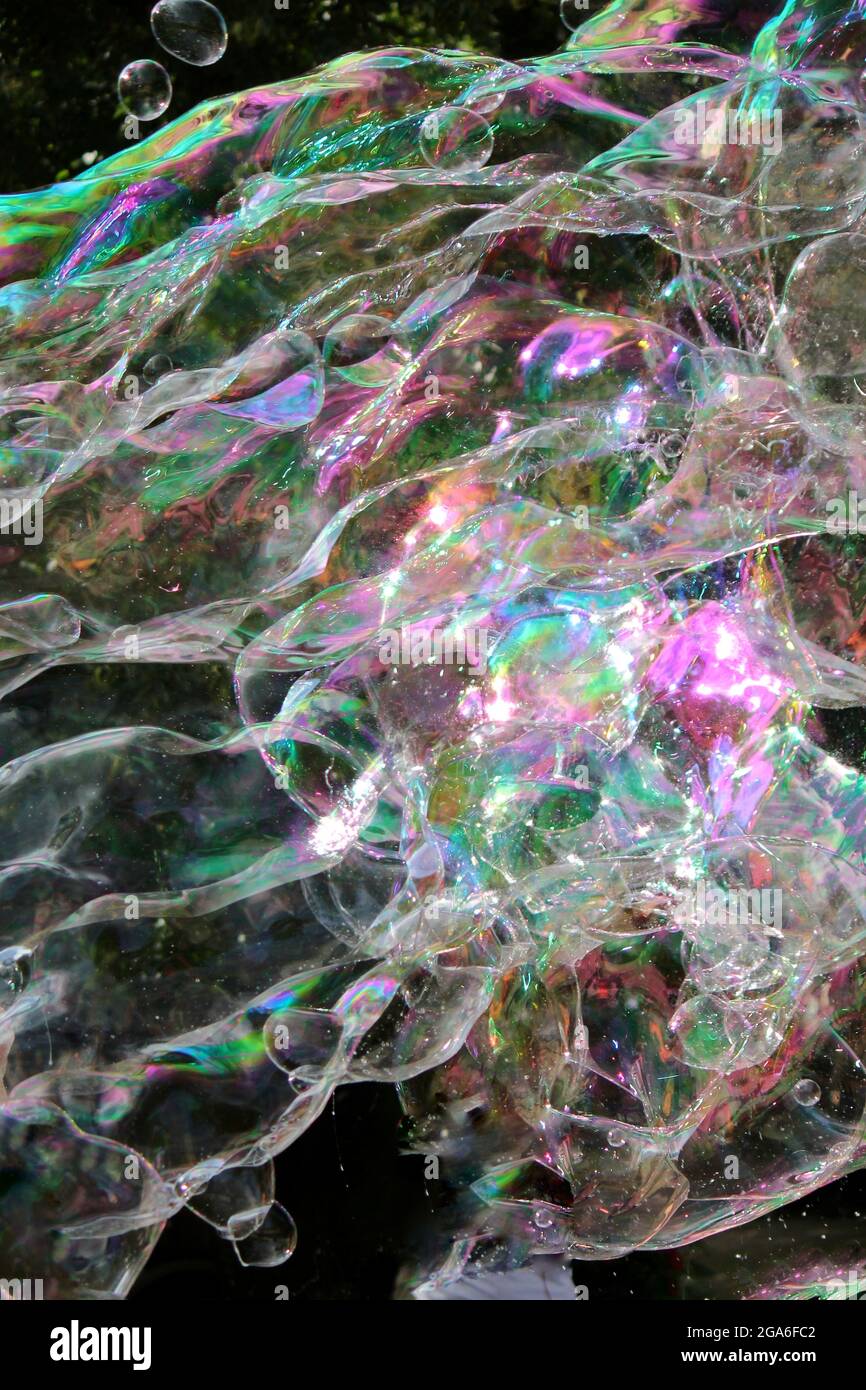 Huge bubbles floating thru the air on a beautiful summer day Stock ...