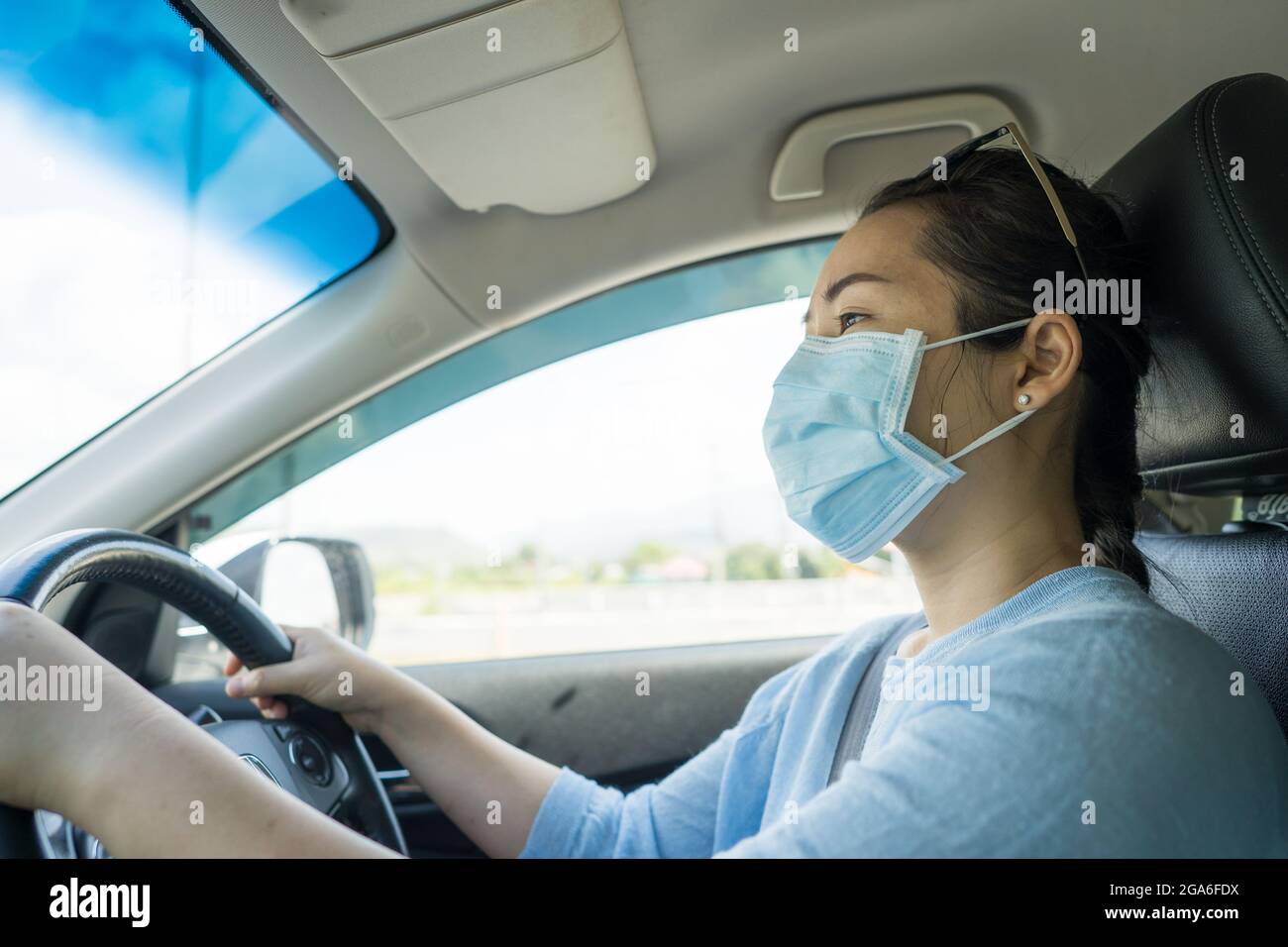 Woman driving wearing medical hi-res stock photography and images - Alamy
