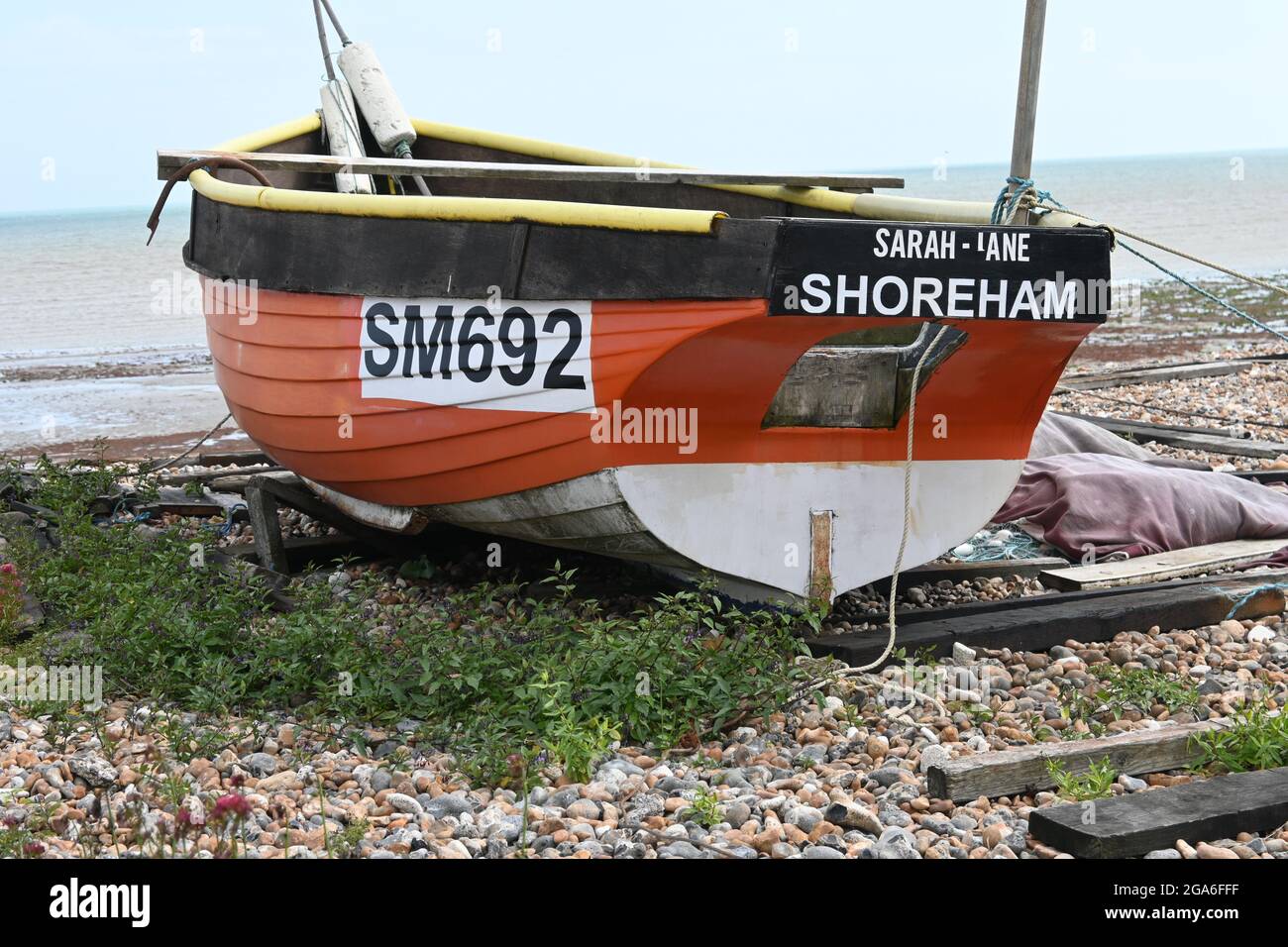 Fishing Boat ashore on Shoreham seafront, East Sussex, UK Stock Photo ...