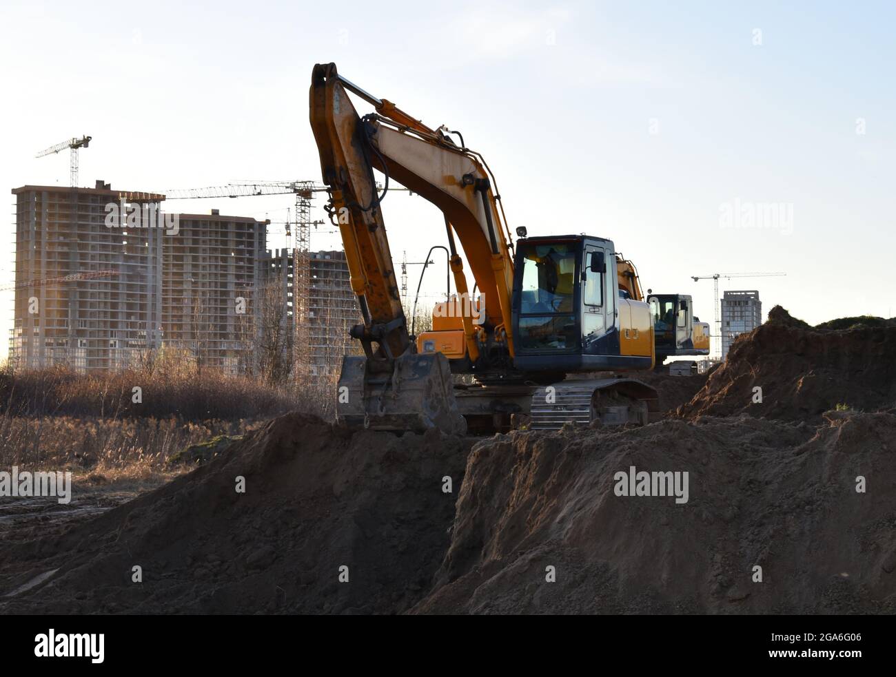 Excavator dig trench at construction site. Digging the pit foundation ...