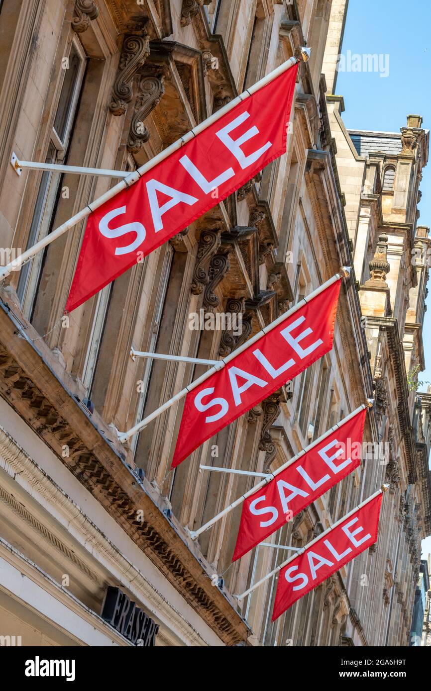 sale flags and signs outside of a major high street retailer store ...