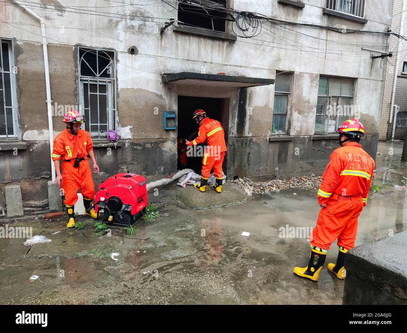 Zhenjiang, China, 28 July 2021.Firefighters clean water at a ...