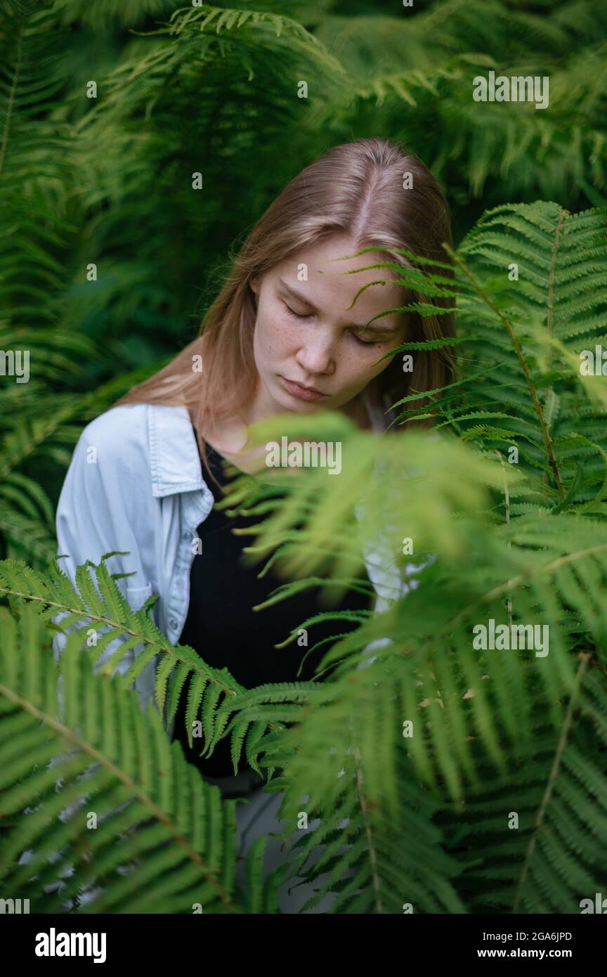 Practice of meditation and interaction with nature. Girl in green ...
