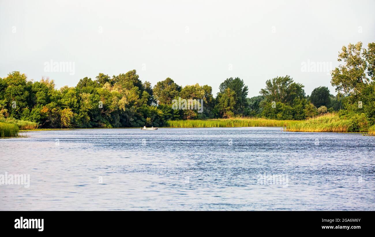 Image of a landscape on the river with a fisherman on a boat Stock ...