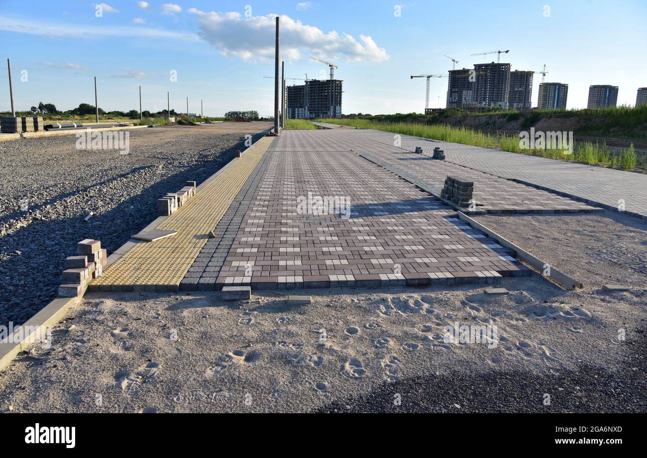 Process of installing paving bricks at construction site. Laying paving ...