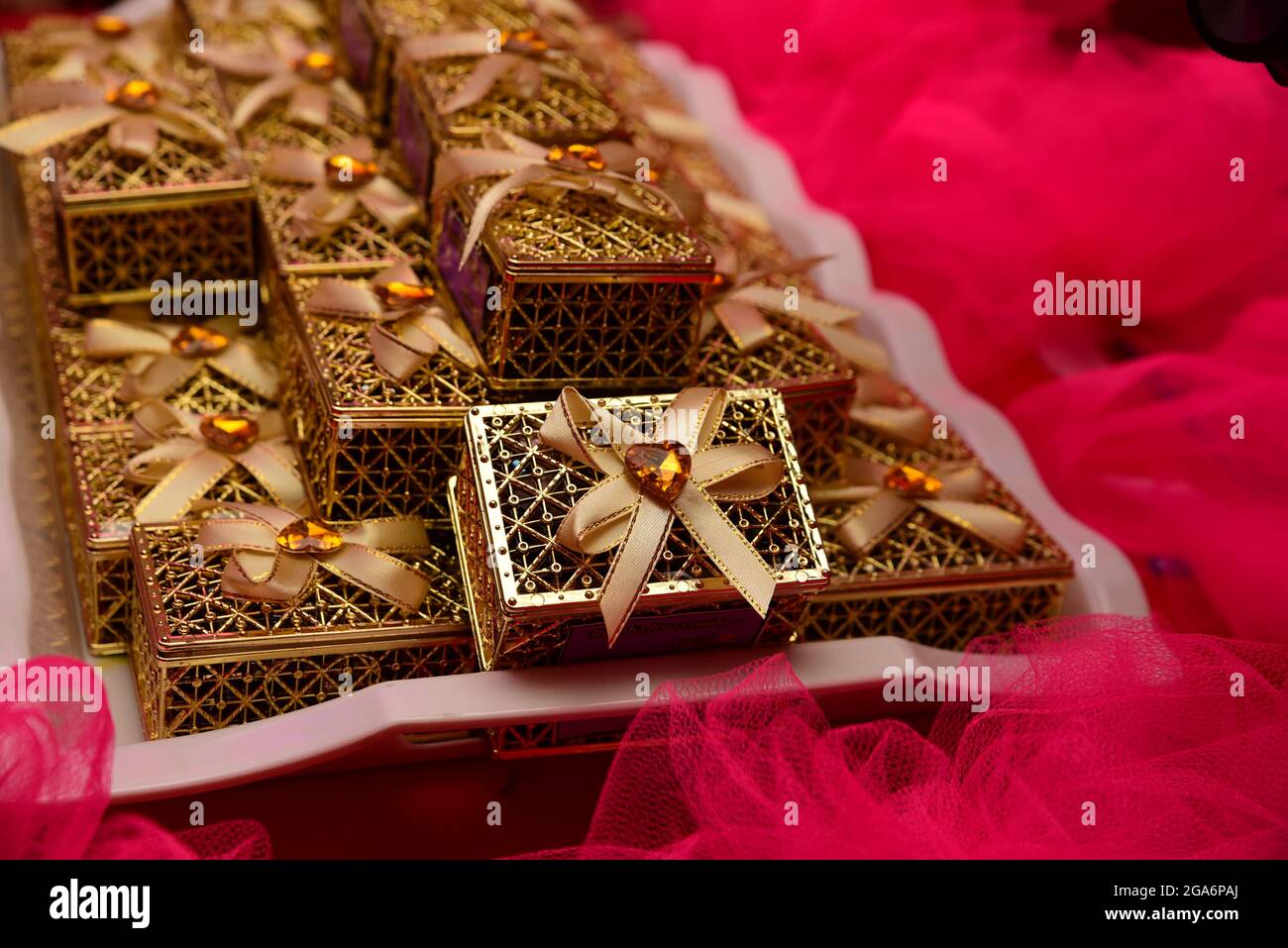 Composition of gifts of different shapes wrapped in golden wrapping ...