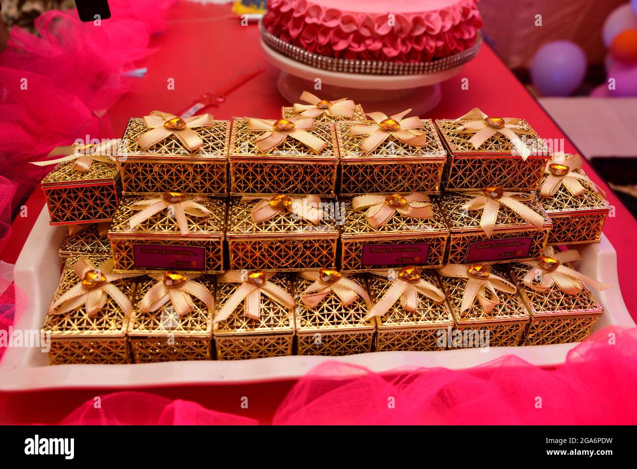 Composition of gifts of different shapes wrapped in golden wrapping ...