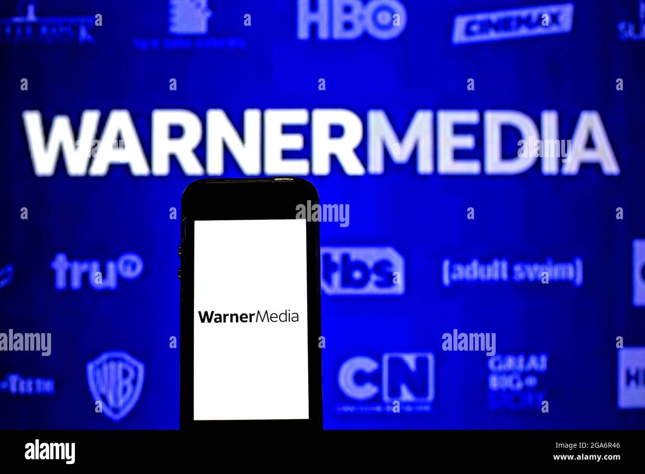 In this photo illustration a WarnerMedia logo seen displayed on a ...