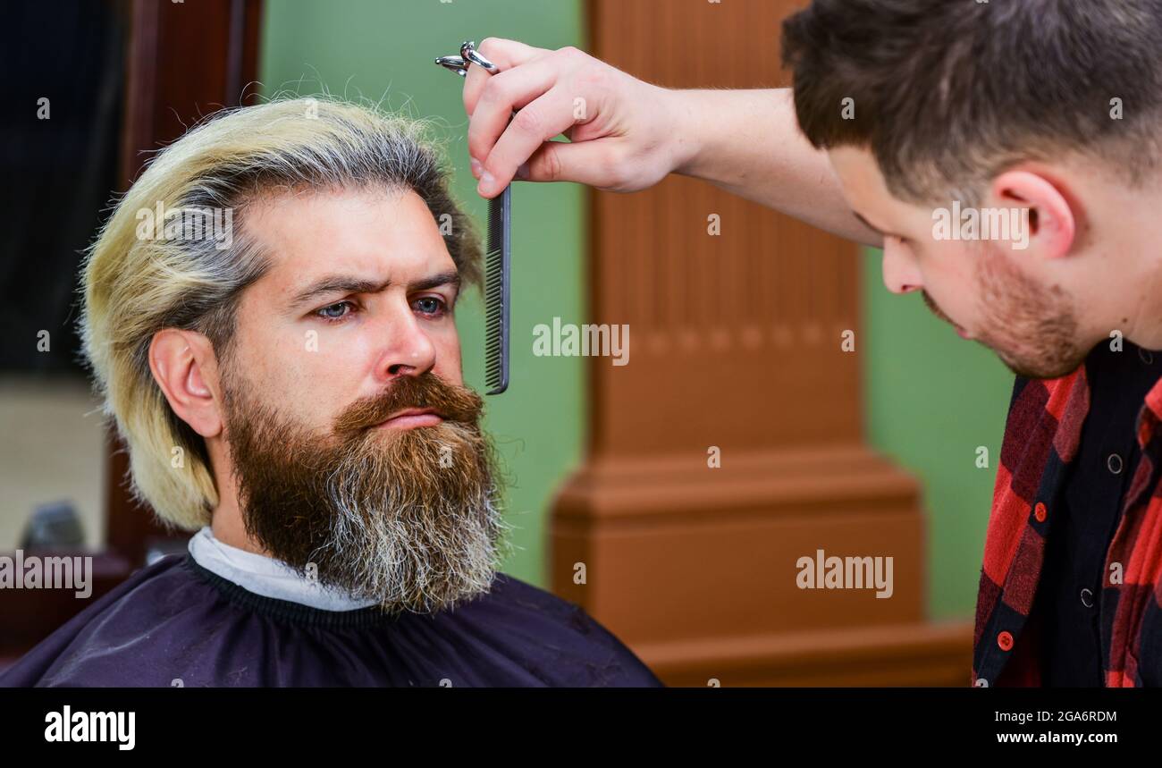 brutal bearded man at hairdresser salon with master, hair style Stock ...