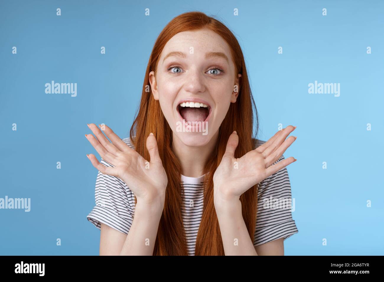 Happy cheerful rejoicing young pretty redhead supportive girlfriend ...