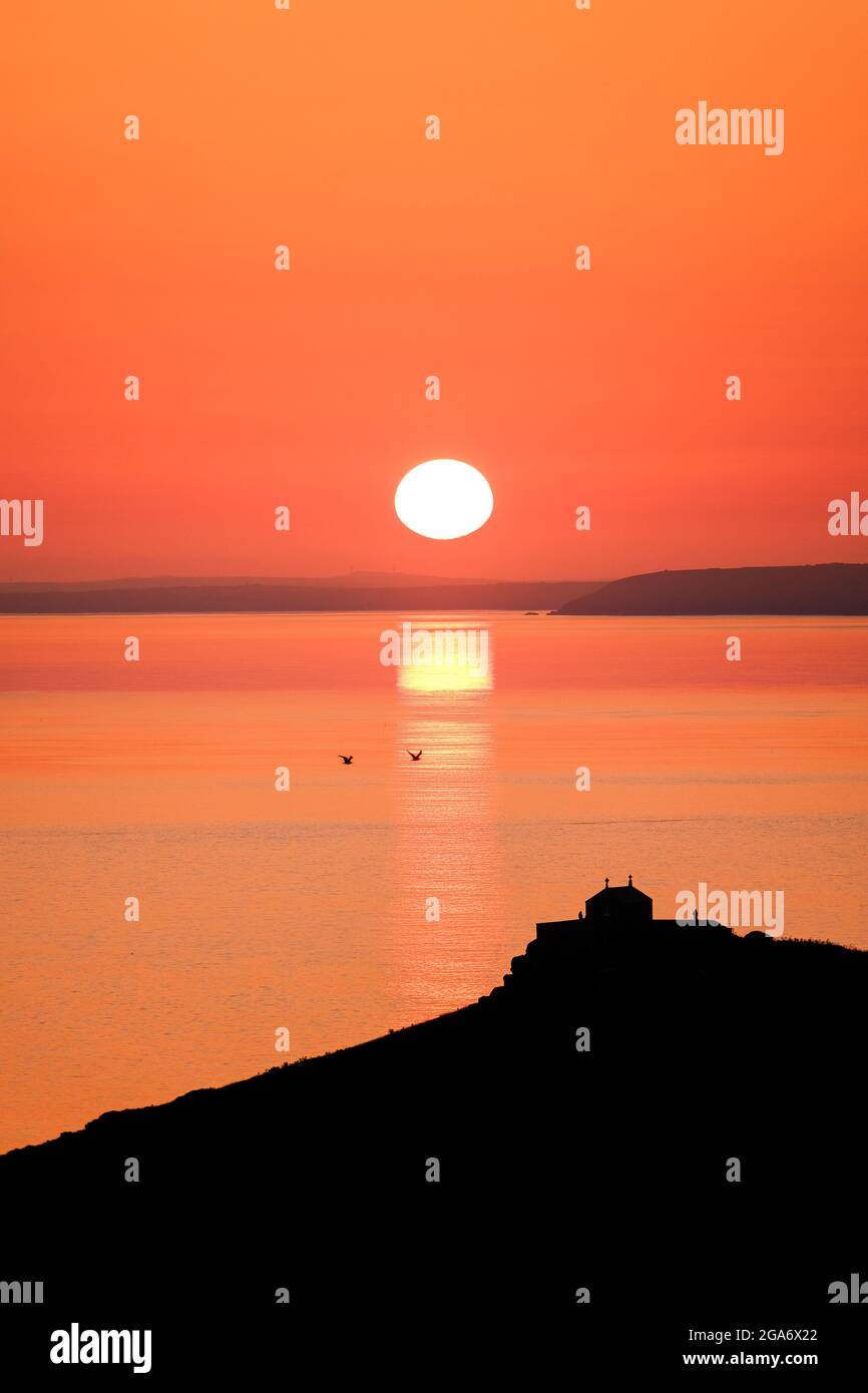 The sun rising over St Ives Bay in Cornwall, UK Stock Photo - Alamy