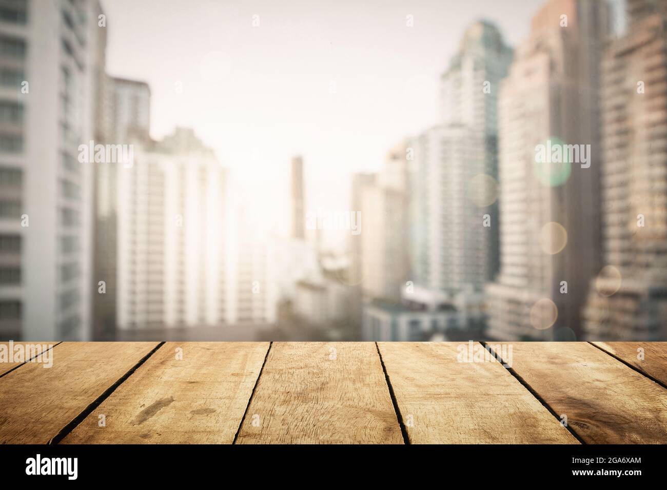 Panoramic empty grunge wood counter table top on blur glass window white light city bokeh ...