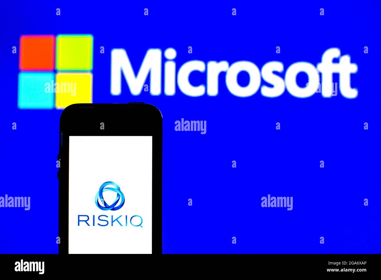 In this photo illustration a RiskIQ logo seen displayed on a smartphone with a Microsoft ...