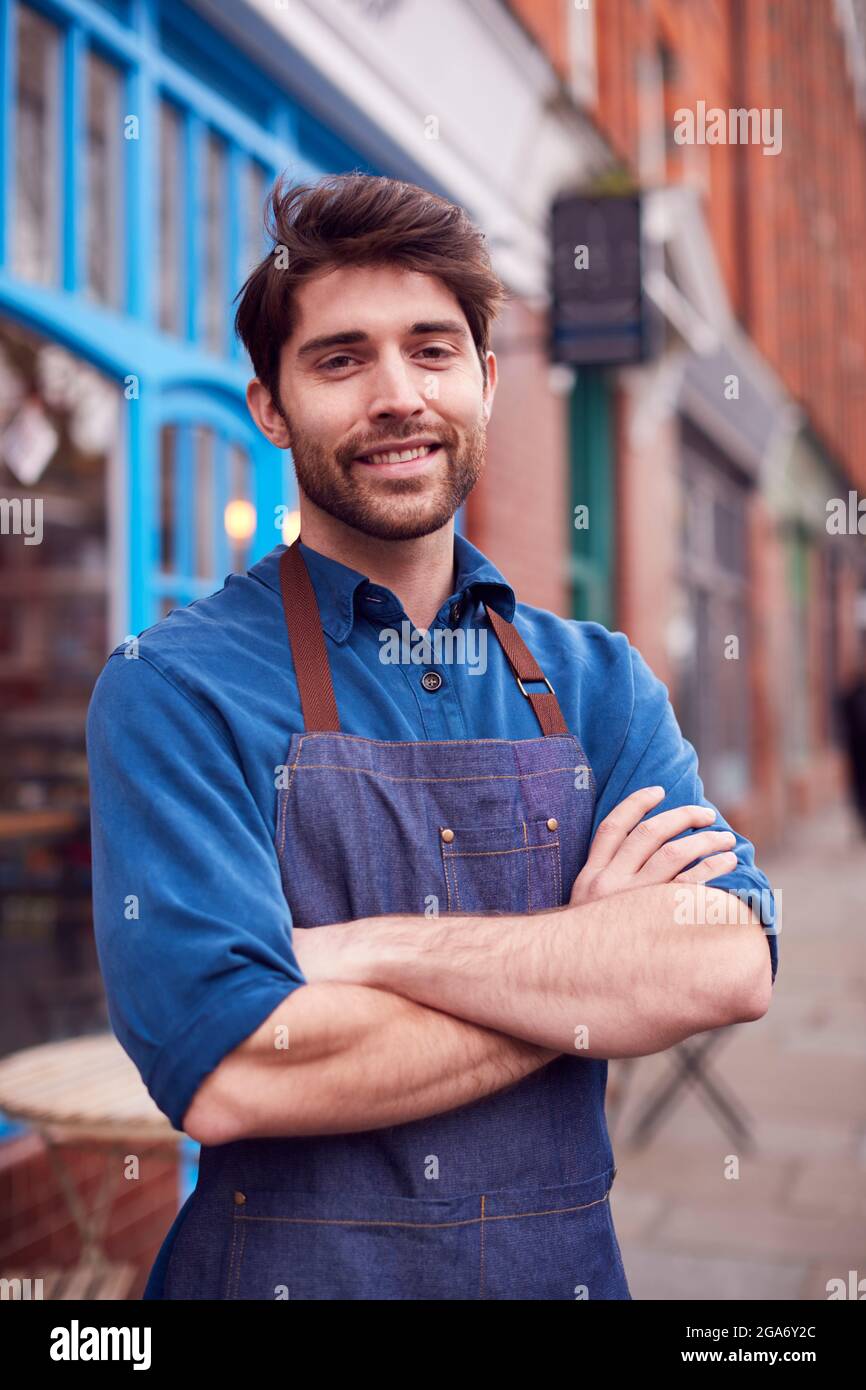 Portrait Of Male Small Business Owner Wearing Apron Standing Outside ...