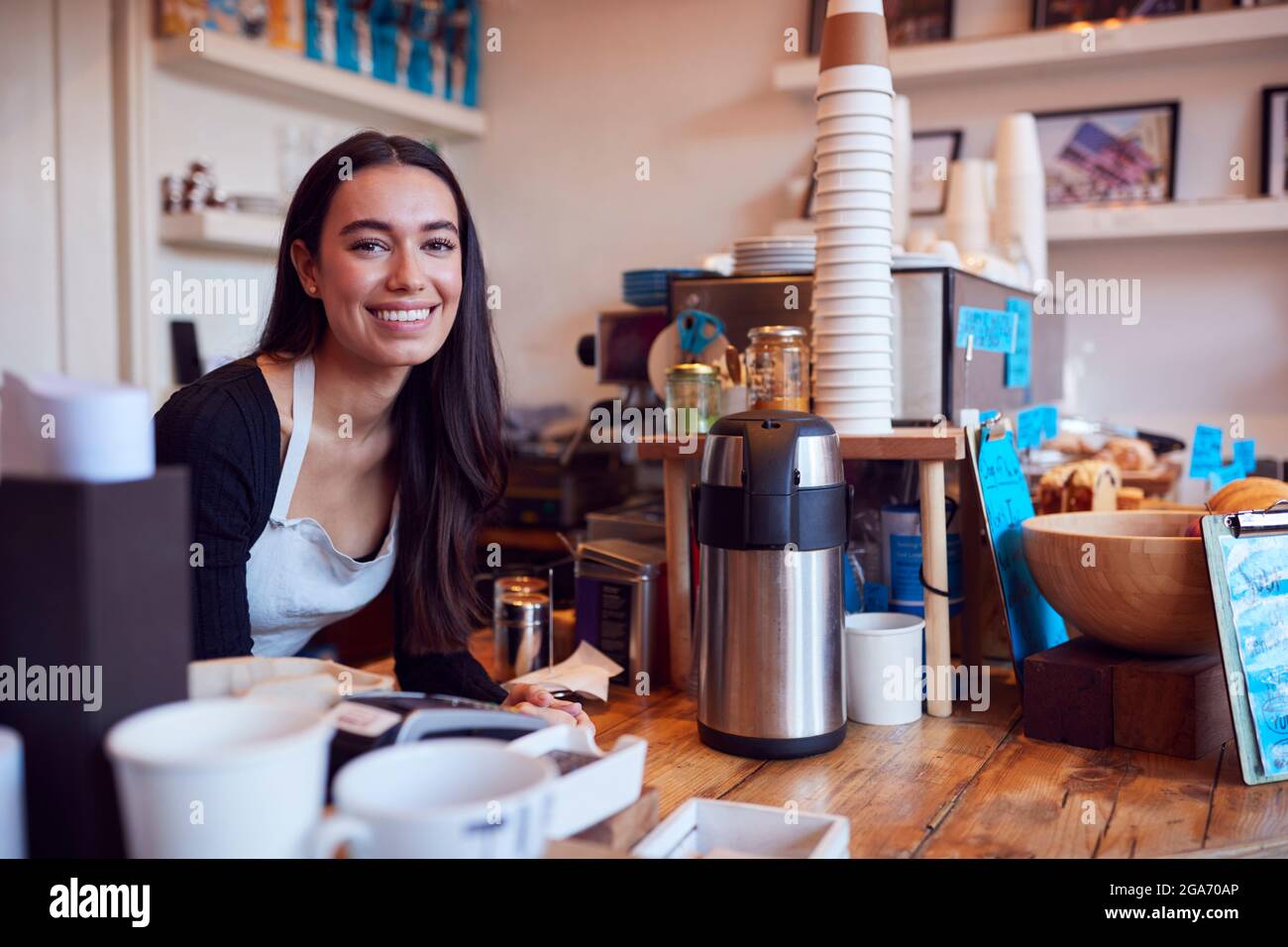 Portrait Of Smiling Female Owner Of Coffee Shop Standing Behind Counter ...