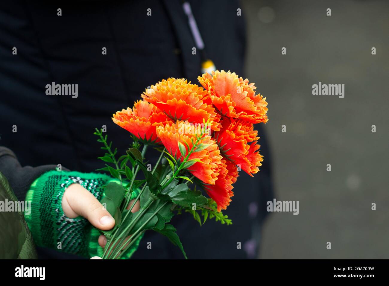 Flowers in a bouquet. Flowers in hand. A commemorative bouquet. People ...