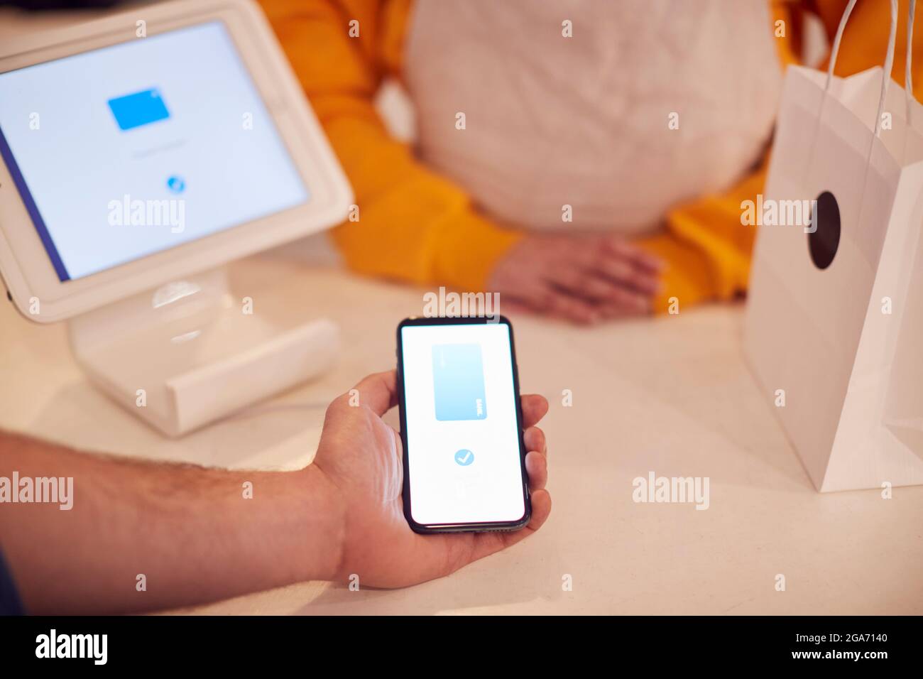 Close Up Of Sales Assistant Accepting Contactless Payment In Shop From ...