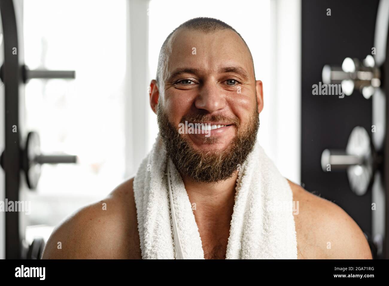 Cheerful smiling man bodybuilder standing in a gym Stock Photo - Alamy